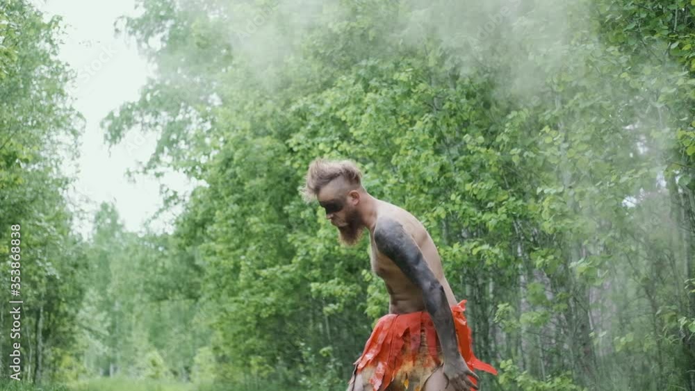 Vidéo Stock savage with painted face, looking at camera, evil eyes ...