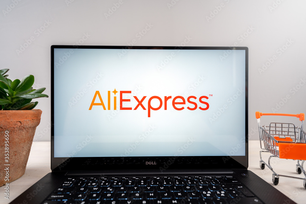Aliexpress logo on laptop next to shopping trolley and money tree plant ...