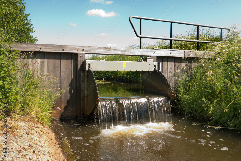 Small overflow dam in a river for controling water level in a nature ...