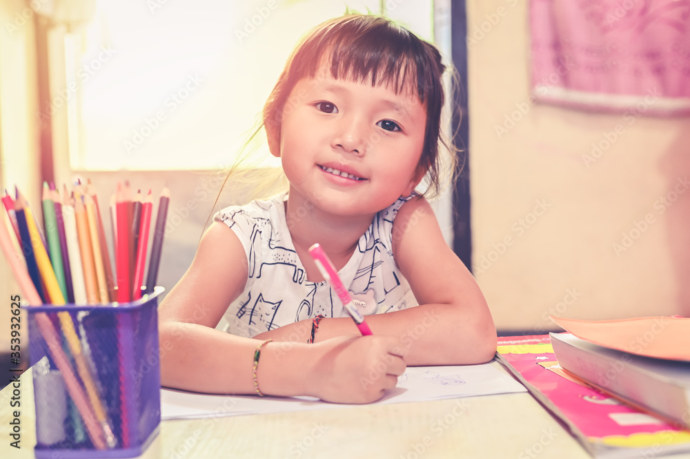 Little School girl looking camera or watching television screen for ...