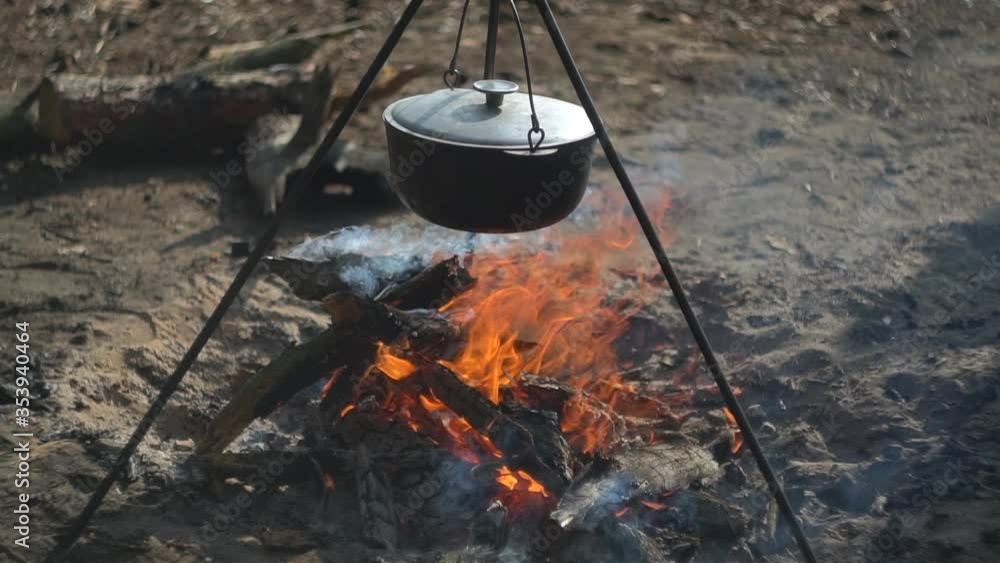 cauldron at the stake. camping in the wood. cooking on the fire. field ...