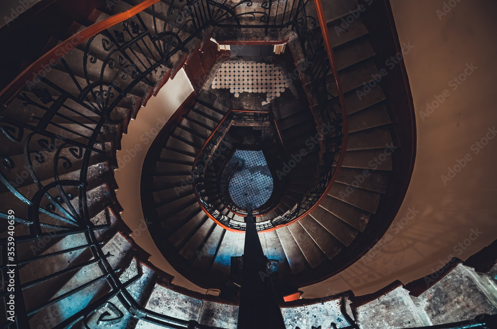Destroyed spiral staircase indoors. Natural light. Beautiful ...