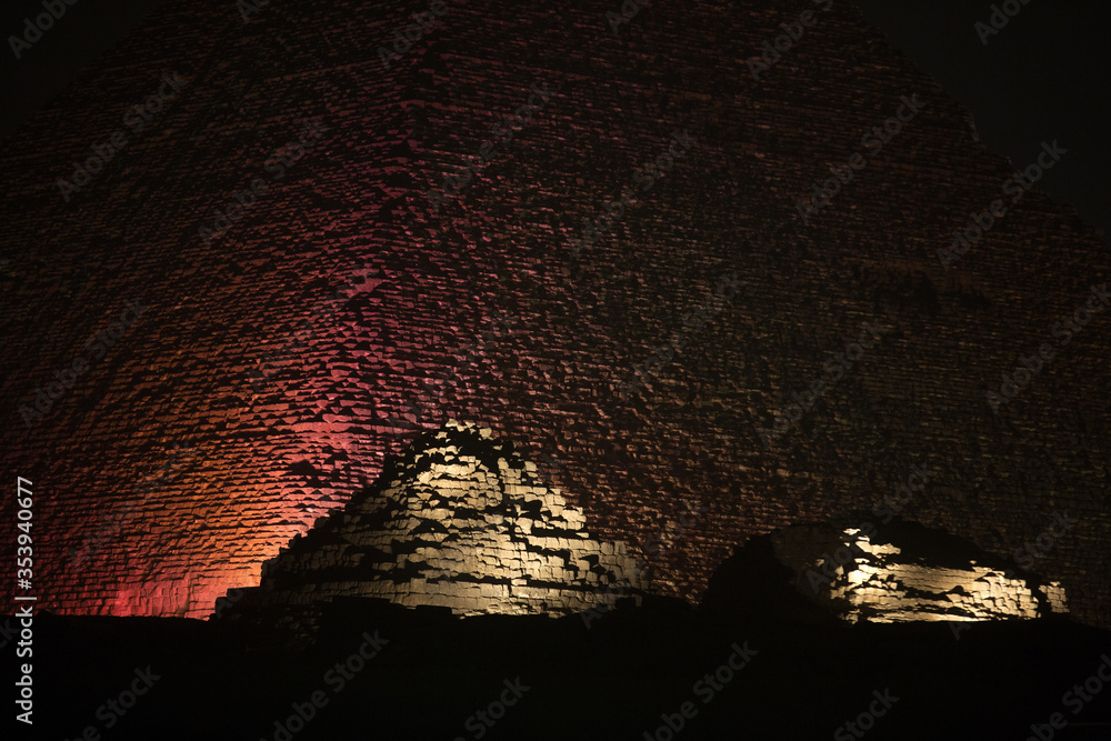 The lighted great Pyramid and the Pyramids of Queen Henutsen and Queen ...