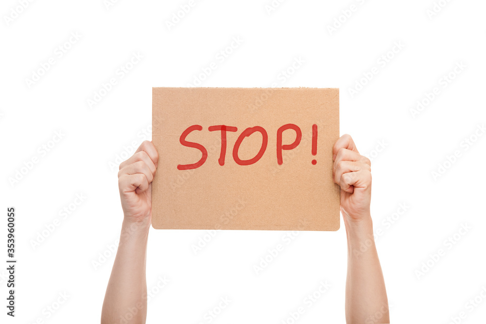 demonstrator hands are holding protest poster with the message Stop ...