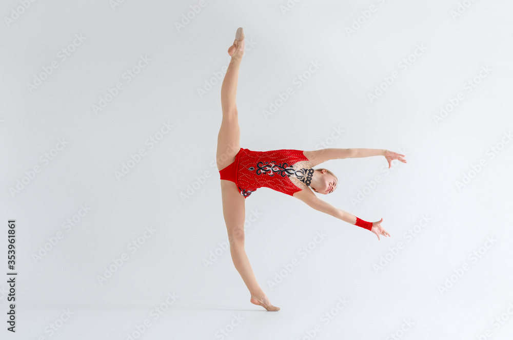 Artistic gymnast in sportswear performing vertical leg split, isolated ...