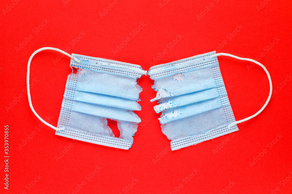 Used, broken, and torn medical face mask. Showing dangerous lack of ppe ...