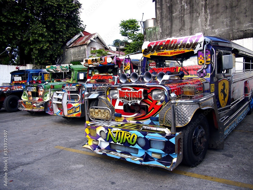 Colorful passenger jeepneys with artistic designs at a jeepney parking ...