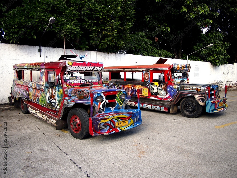 Colorful passenger jeepneys with artistic designs at a jeepney parking ...