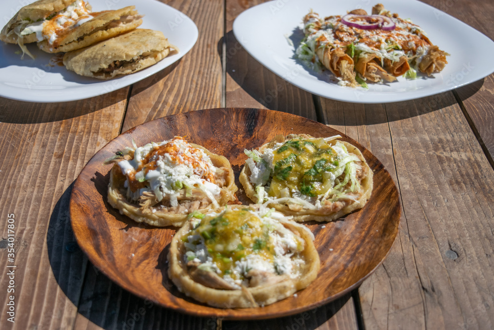 variety of Mexican food dishes. sopes, tacos, gorditas stuffed. Stock ...