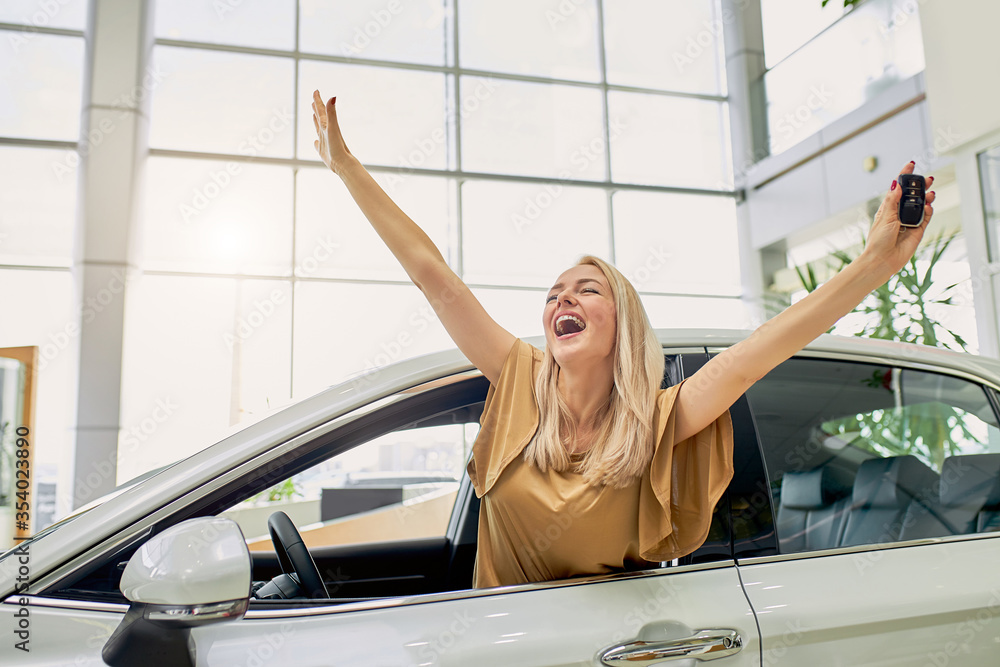 beautiful happy female got keys by her new automobile, dreams come true ...