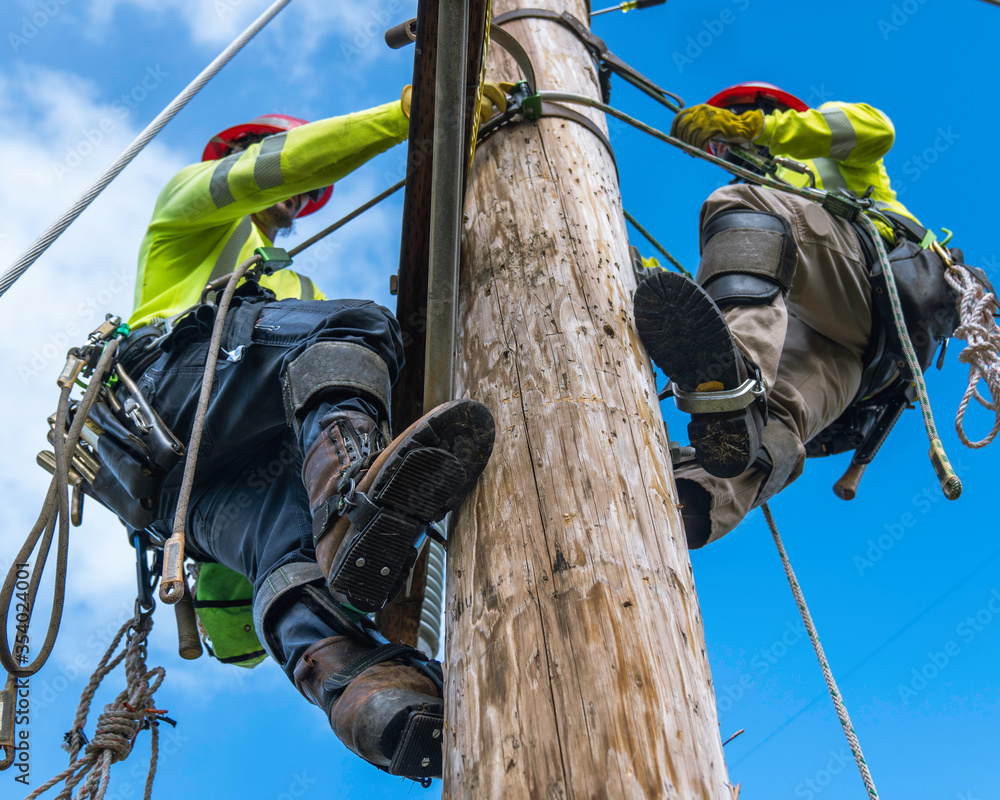 Lineman Asending Utility Pole Stock Photo | Adobe Stock