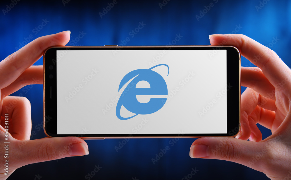 Hands holding smartphone displaying logo of Internet Explorer Stock ...
