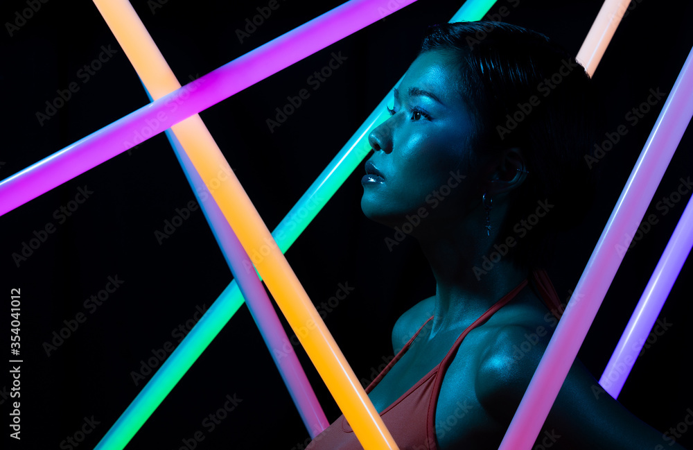 Face Close up of High Fashion Trend Cosmetic make up with NEON tube ...