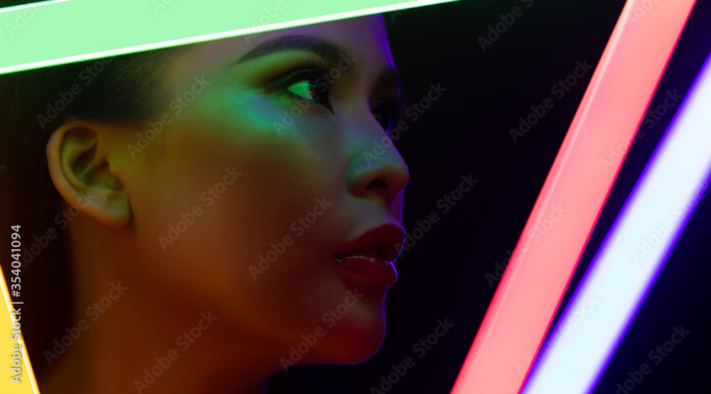 Face Close up of High Fashion Trend Cosmetic make up with NEON tube ...