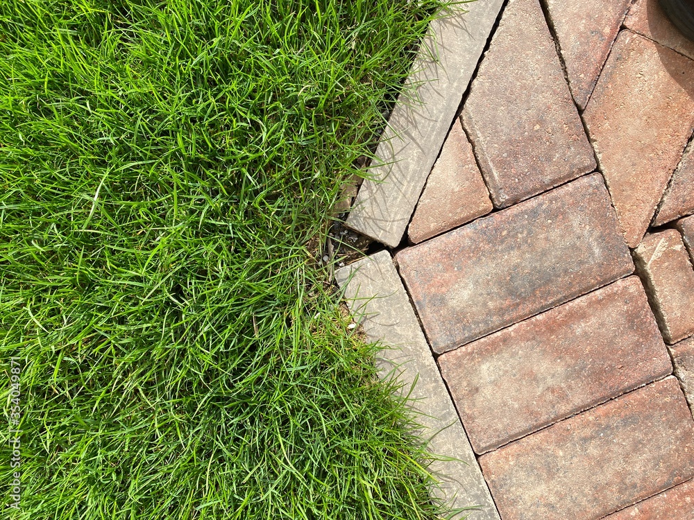 Red monoblock paving bricks and edge slab on new house garden Stock ...