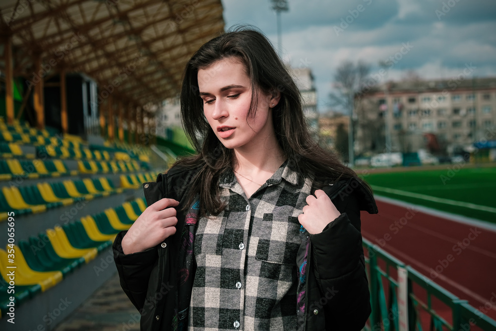 Young woman walking at a track and field stadium Stock Photo | Adobe Stock