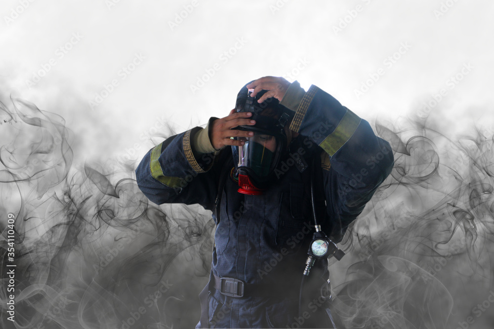 Firefighter in uniform in protective breathing mask on his head with ...