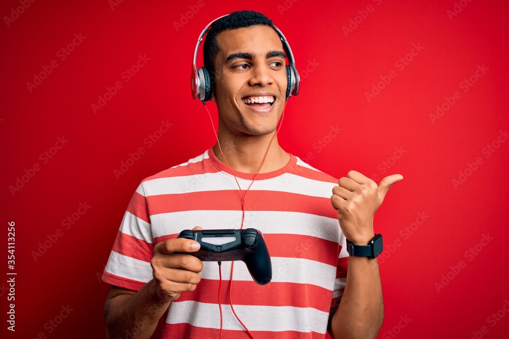 Handsome african american gamer man playing video game using jostick ...