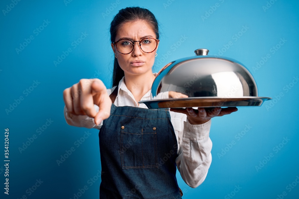Young beautiful waitress woman with blue eyes holding tray with dome ...