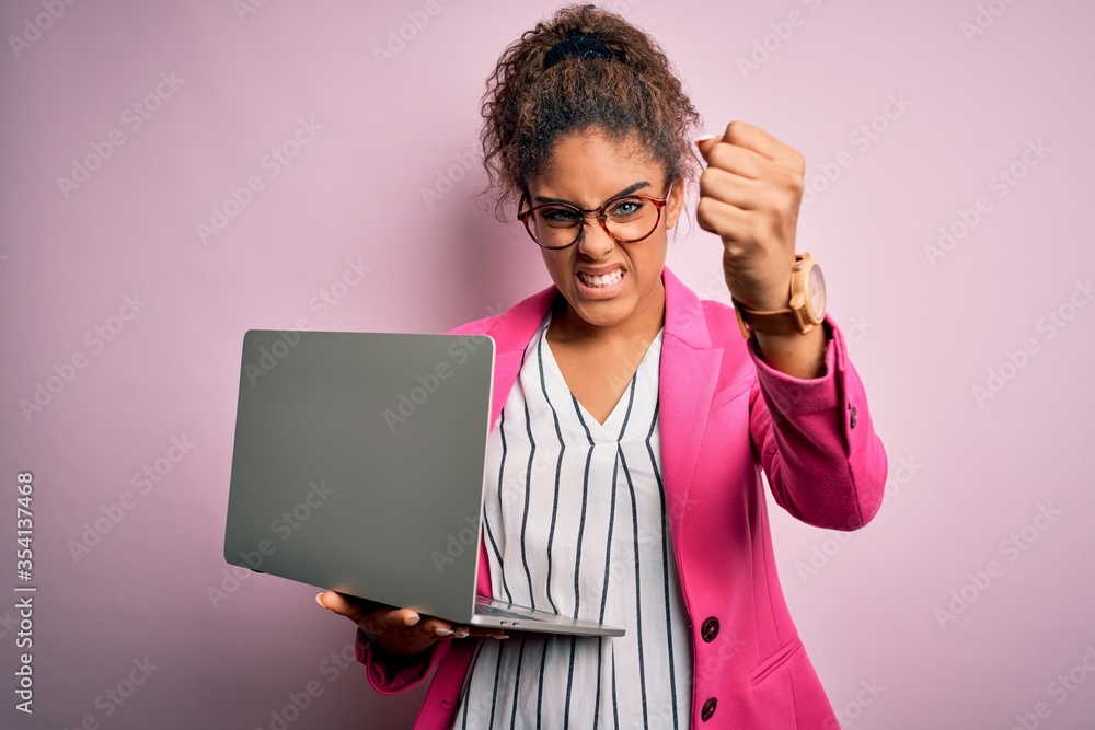 African american business woman wearing glasses working using laptop ...