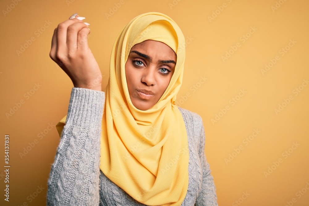 Young beautiful african american girl wearing muslim hijab over ...