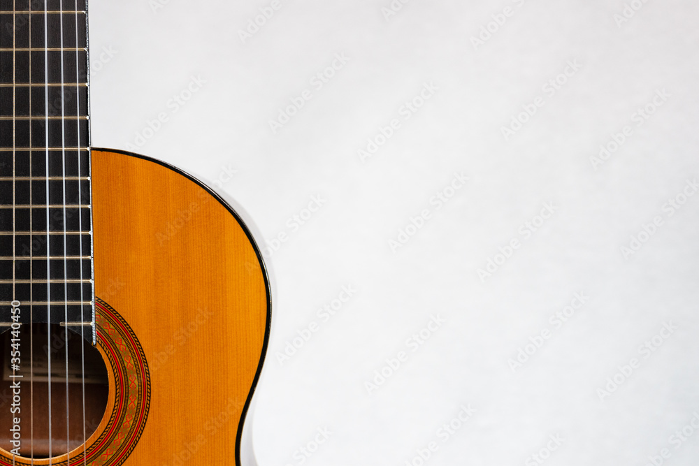 Acoustic guitar placed on the left side in landscape format on a light ...