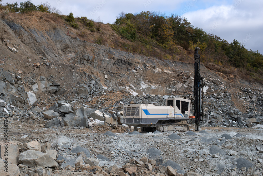 Drilling rig prepares blasting operations in a stone quarry Stock Photo ...