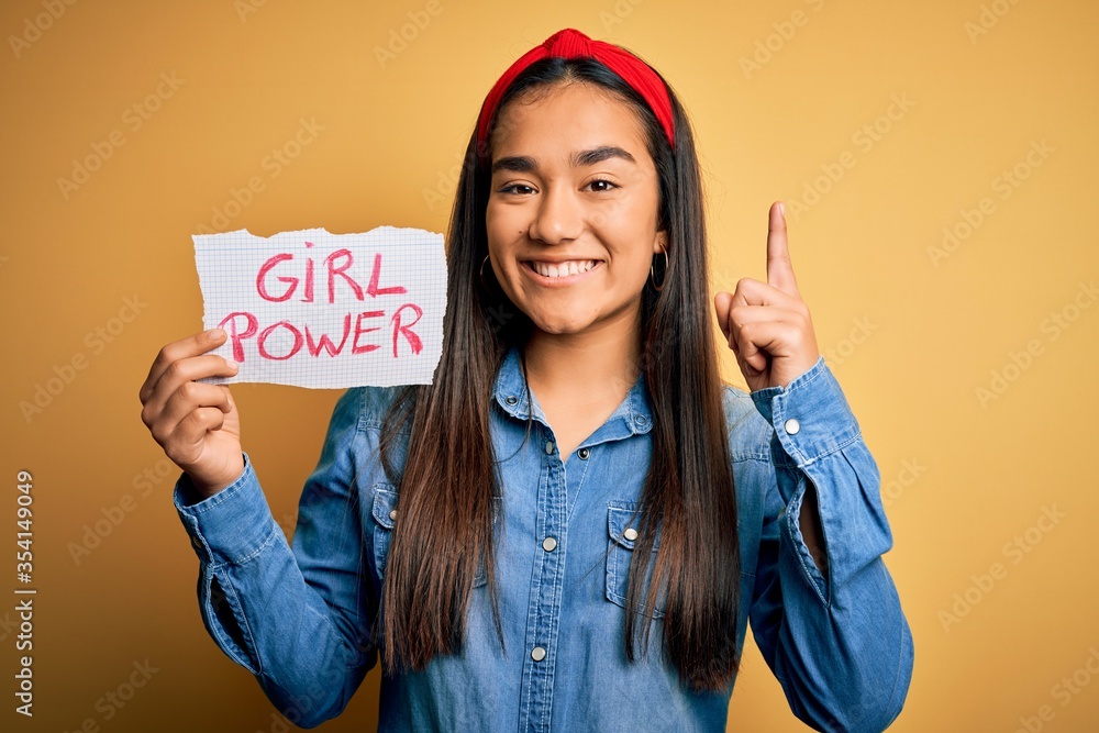 Young beautiful asian woman wearing diadema holding banner with girl ...