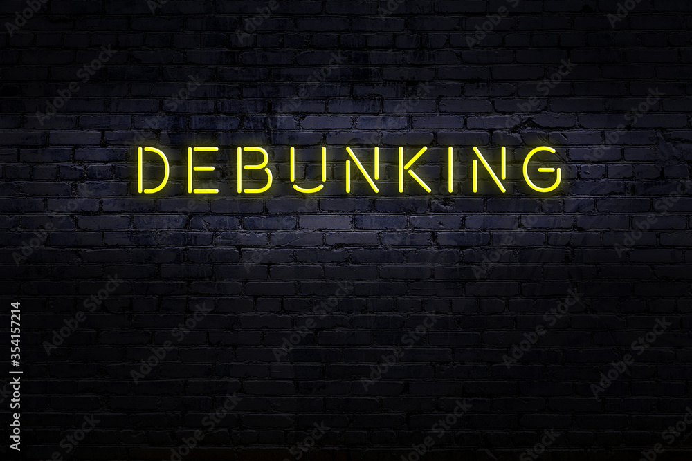Neon sign. Word debunking against brick wall. Night view Stock ...