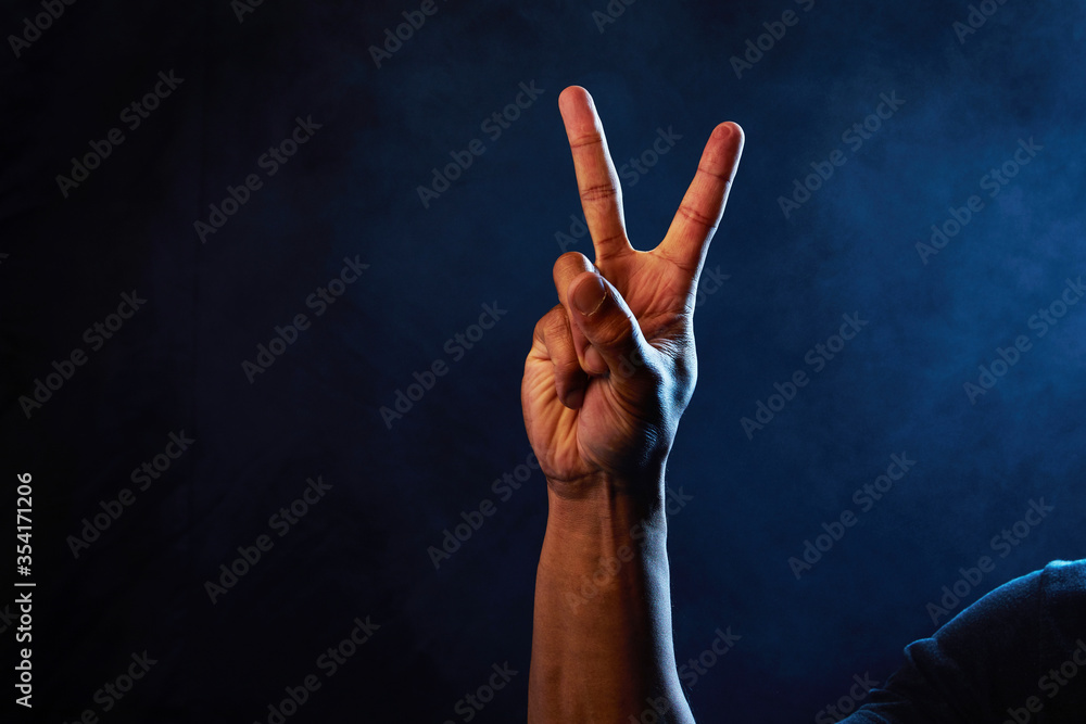 Studio image of an African American hand showing the peace sign symbol ...