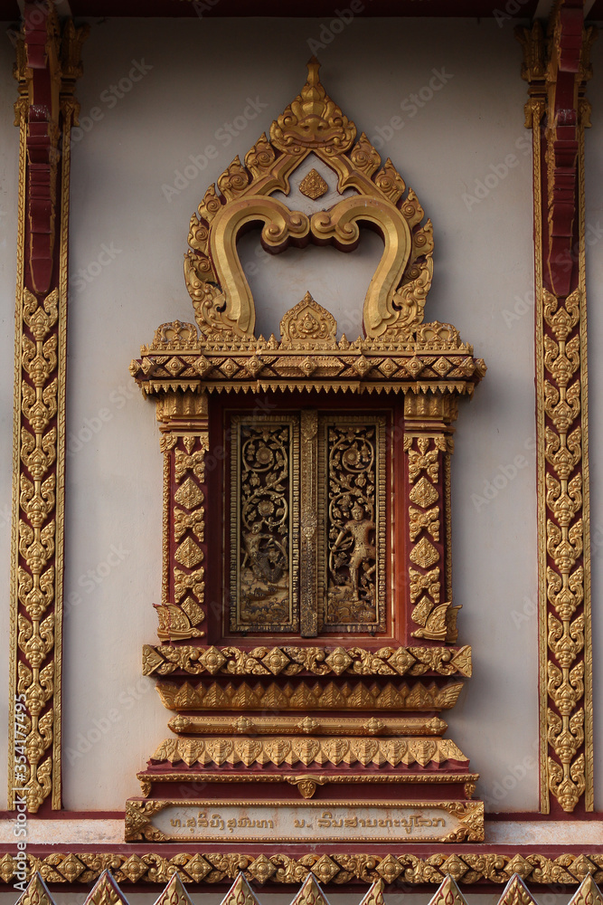 Decorative window with wood carving blinds and golden ornamental frame ...