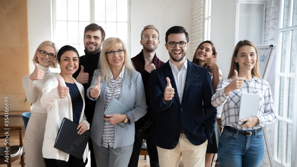 Excited group of diverse different ages businesspeople looking at ...