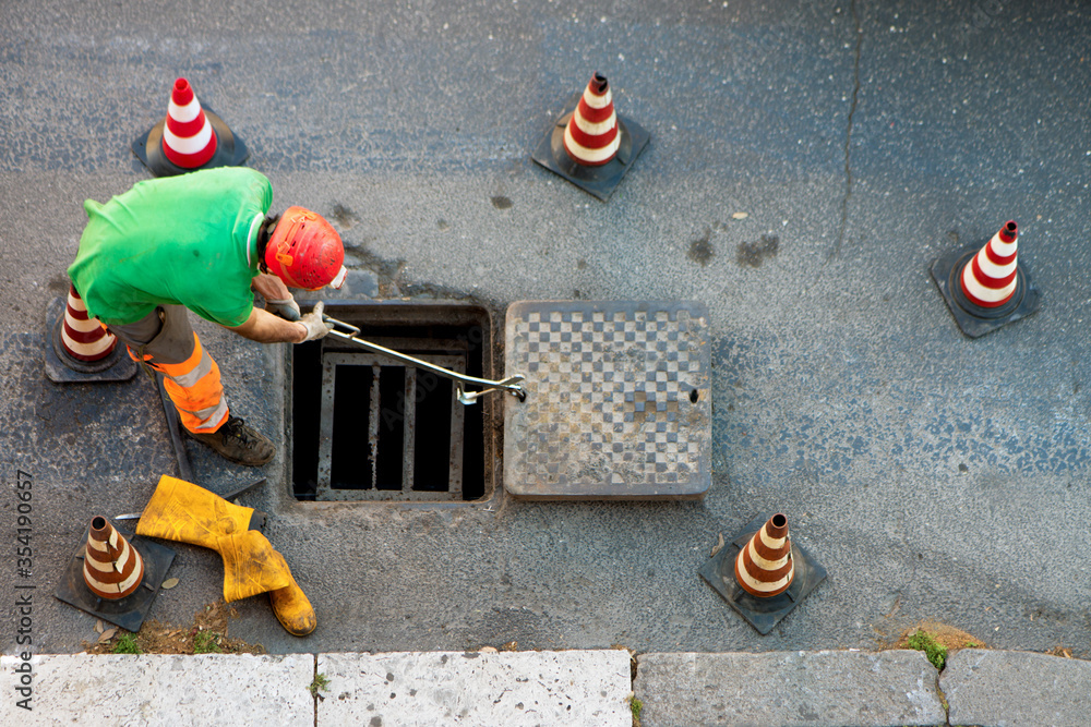 sequence of worker going in the manhole in the street, step 7 Stock ...