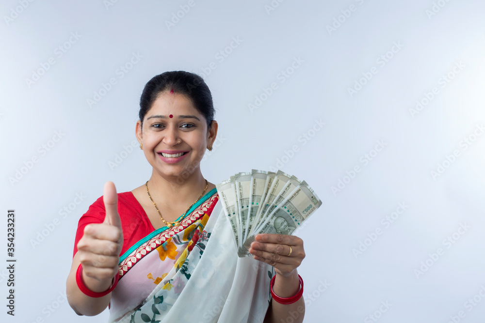Young woman holding Indian rupee notes Stock Photo | Adobe Stock