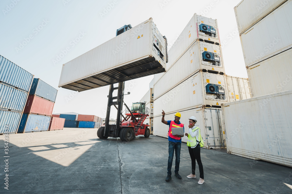 Two Black foreman man & woman worker working checking at Container ...