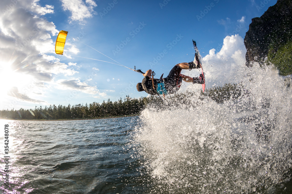 professional kiter makes the difficult trick on a beautiful background ...