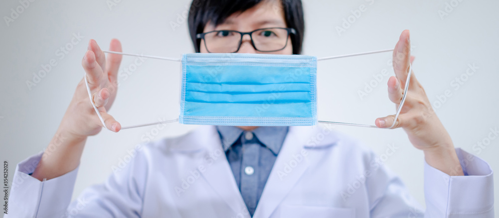 Male Asian doctor or Physician man showing how to wear surgical mask in ...