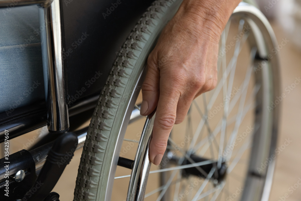 Close up view elderly female hand on rotary ring of self-propelled ...