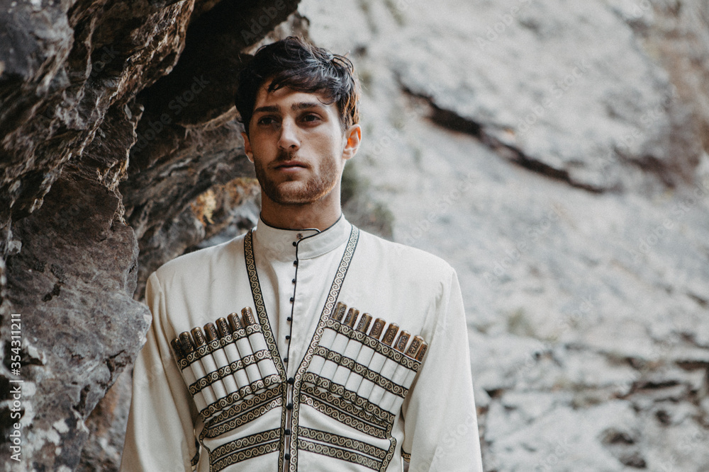 noise effect, selective focus: stylish Georgian man dressed in white ...