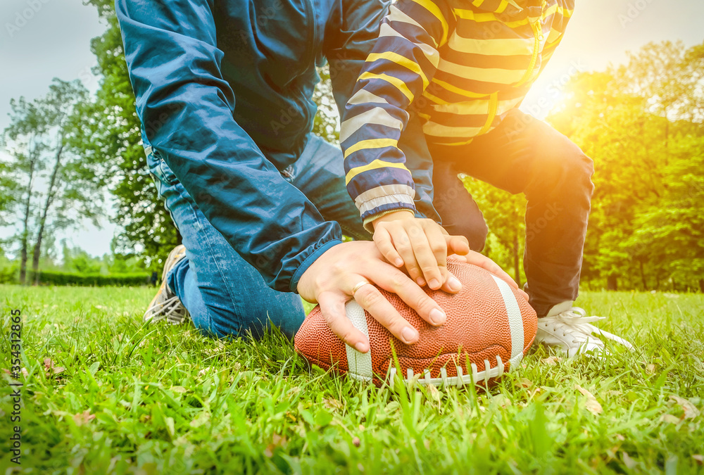 Father and son playing football, Father's day, Playful Man teaching Boy ...