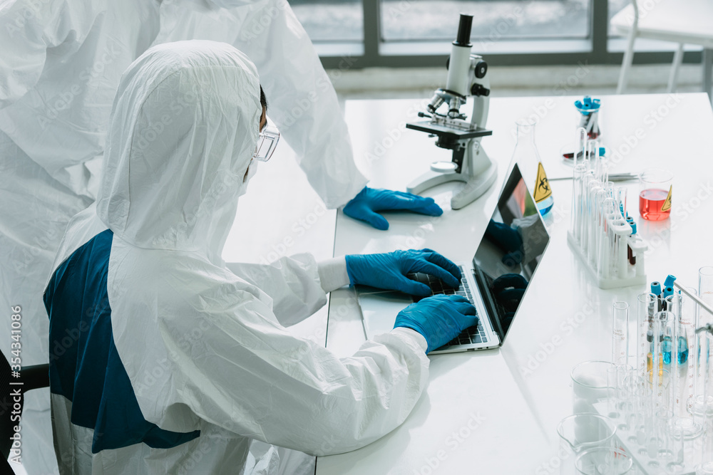 Lab Technician in Personal protective equipment PPE suit Vaccines ...