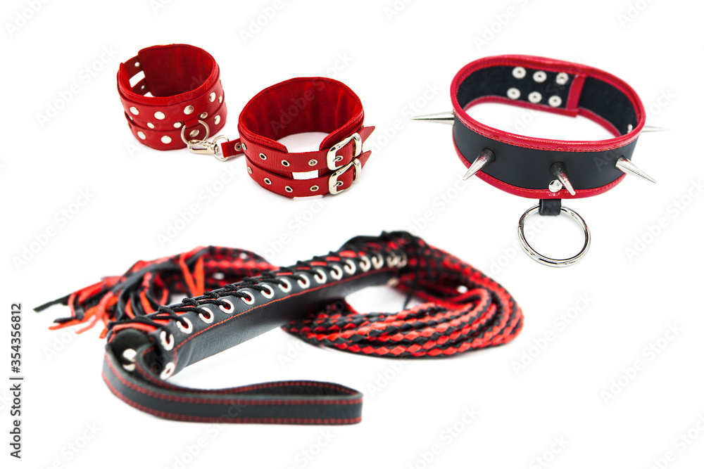 Sexy toys. Leather whip, collar with spikes and handcuffs isolated on ...