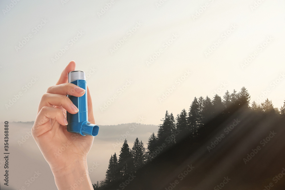 Woman with asthma inhaler and beautiful mountains on background ...