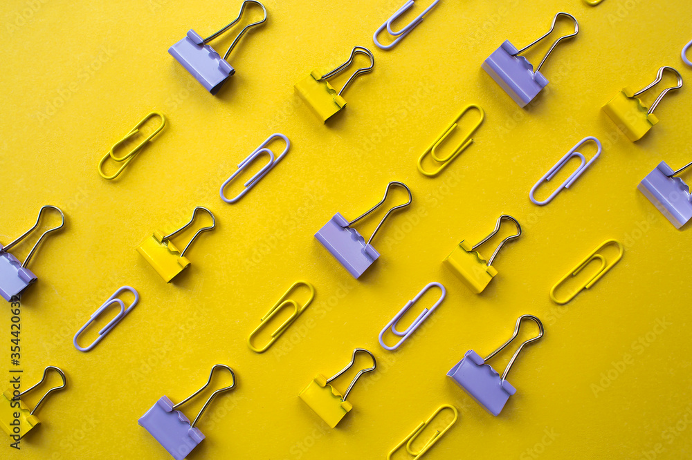 Colorful background with office supplies. Paper clips and paper clips ...