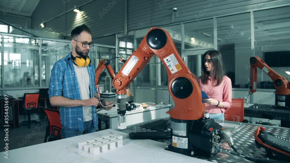 Science analysts are observing a robotic claw in motion. Modern ...