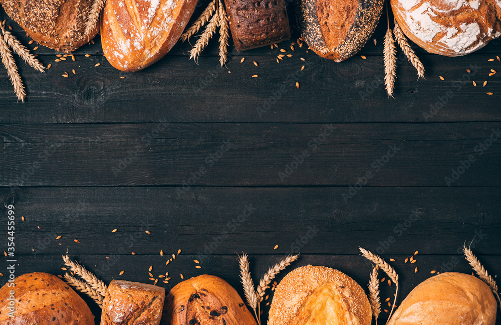 Bread border on wood background with copy space. Vertical composition ...