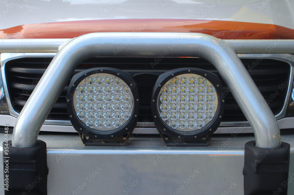 Pair round black LED driving lights and bull bar on the front of a four ...
