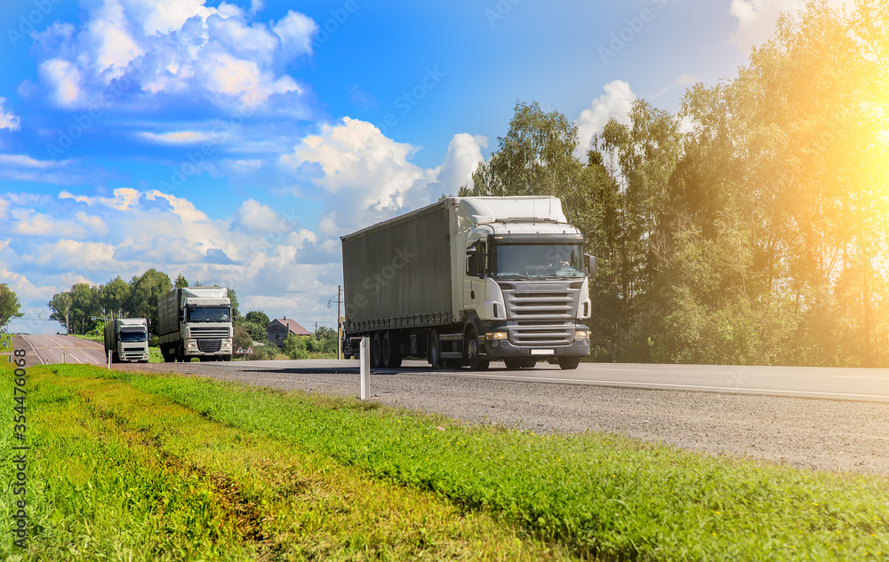 Poster Truck convoy delivers goods on a country road – Wall Art | UkPosters