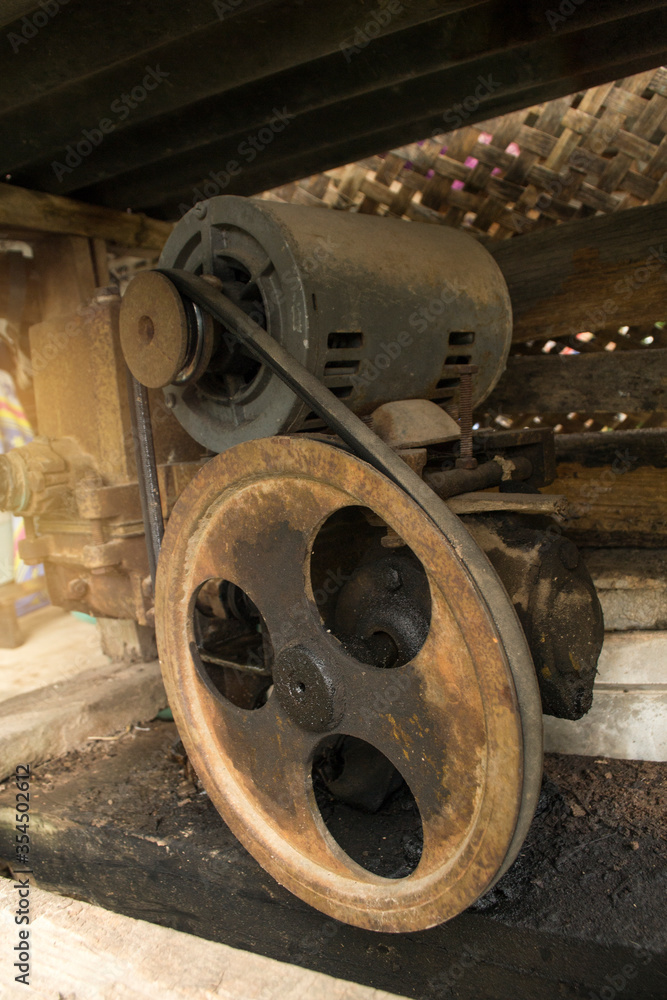 Electric piston pump driven by belt and pulleys. Stock Photo | Adobe Stock