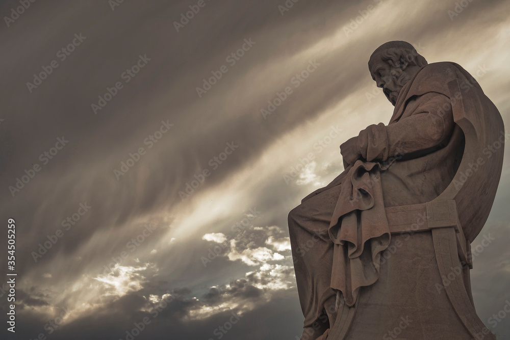 Plato tstue the ancient Greek philosopher, under impressive cloudy sky ...